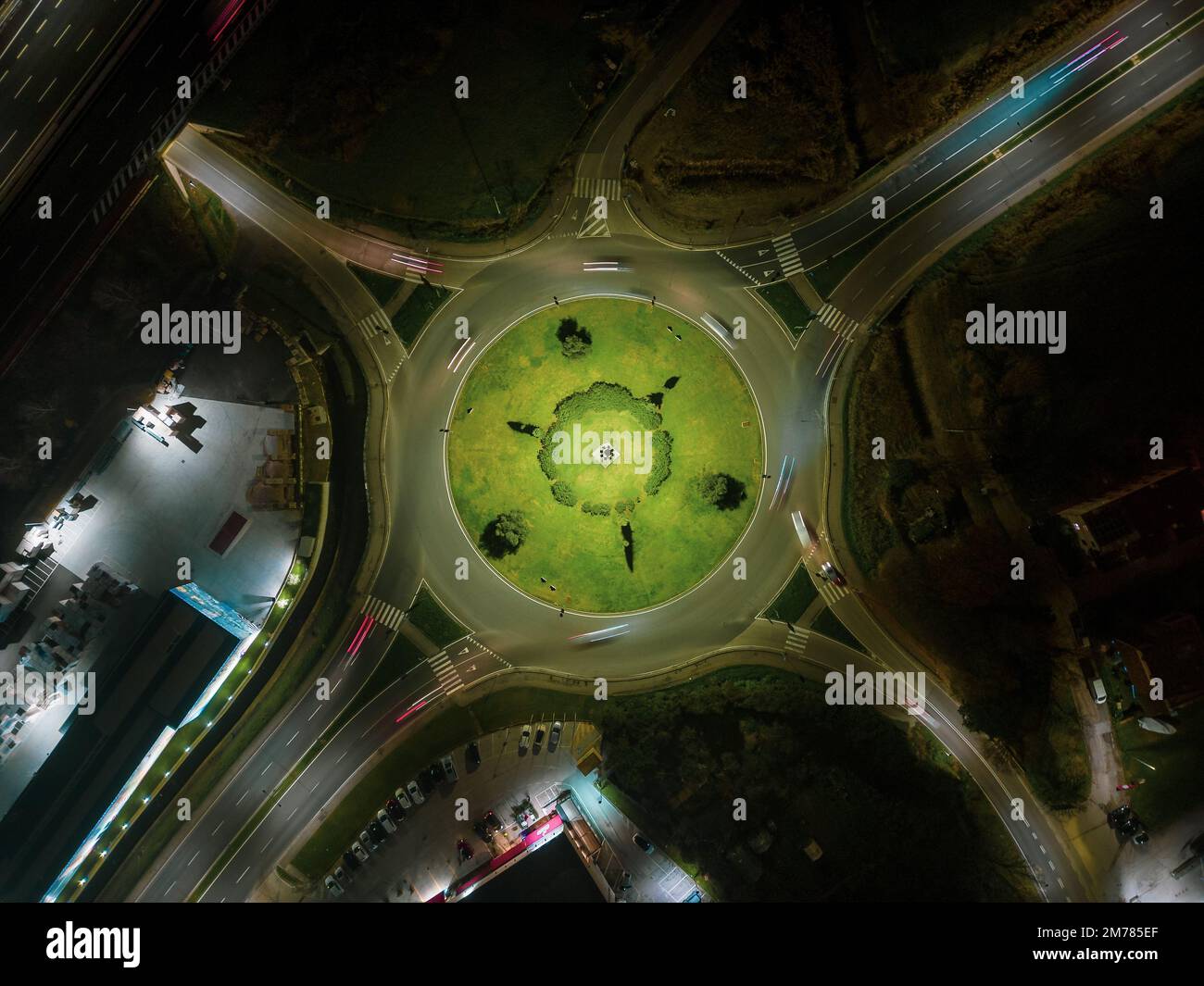 night view of a road busy with cars regulated by a roundabout. the slow ...