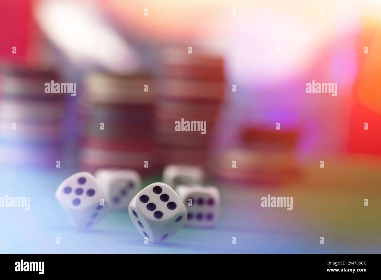 White dice on a green felt table with bokeh background Stock Photo - Alamy