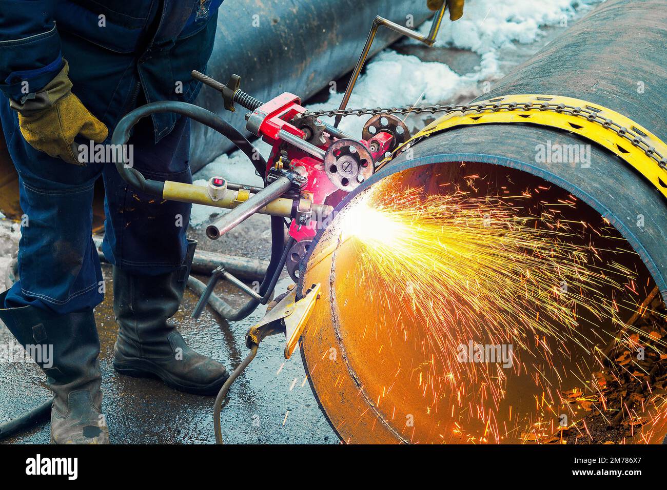 Working welder cuts metal and sparks fly. Gas cutting of large diameter ...