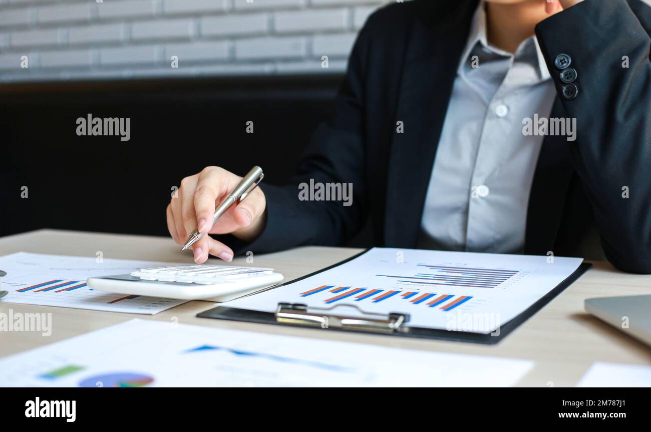 Accounting businessmen are calculating income-expenditure and analyzing ...