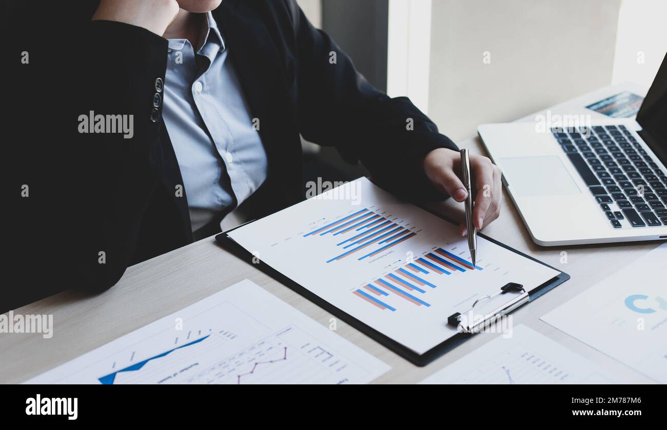 Financial businessmen analyze the graph of the company's performance to ...