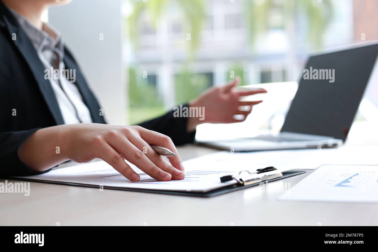 Financial or accounting professionals use a computer to analyze the ...