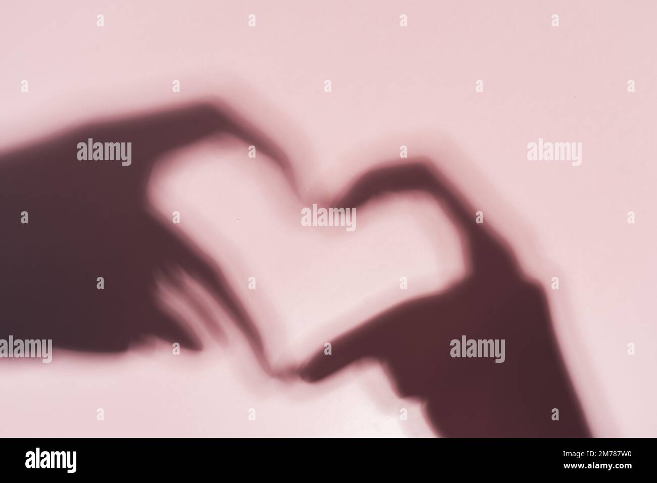 Heart shape hands shadow on hi-res stock photography and images - Alamy