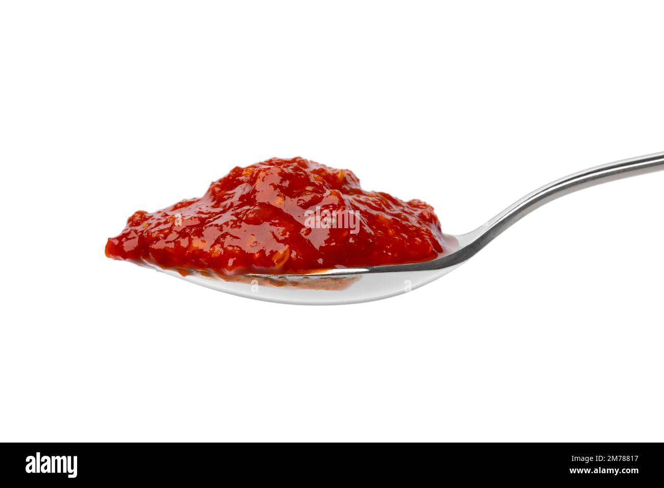 Metal spoon with red sambal, Indonesian chilli sauce, close up on white ...