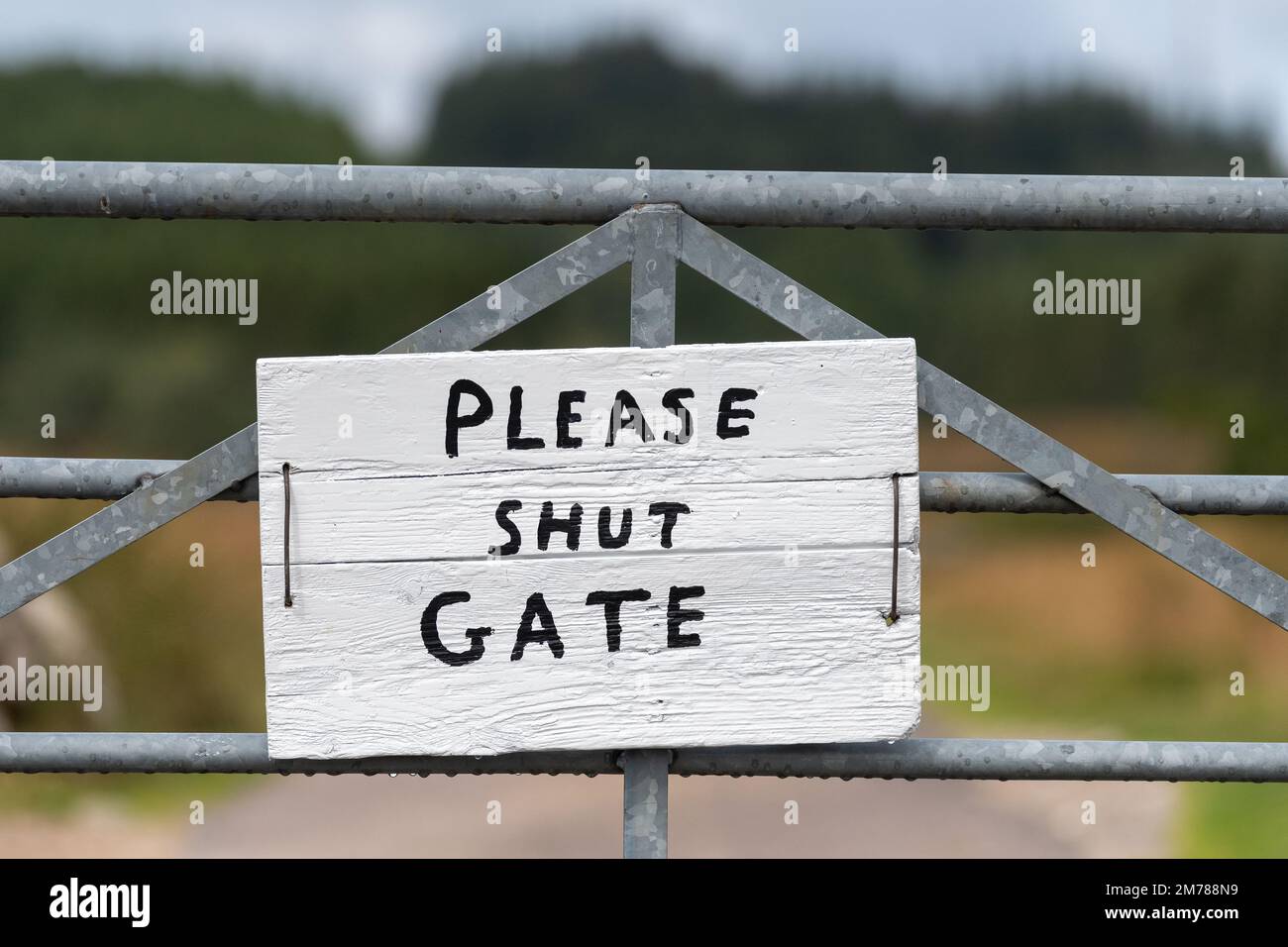 Narrow country lane with a gate on, sign on the gate saying "Shut the ...