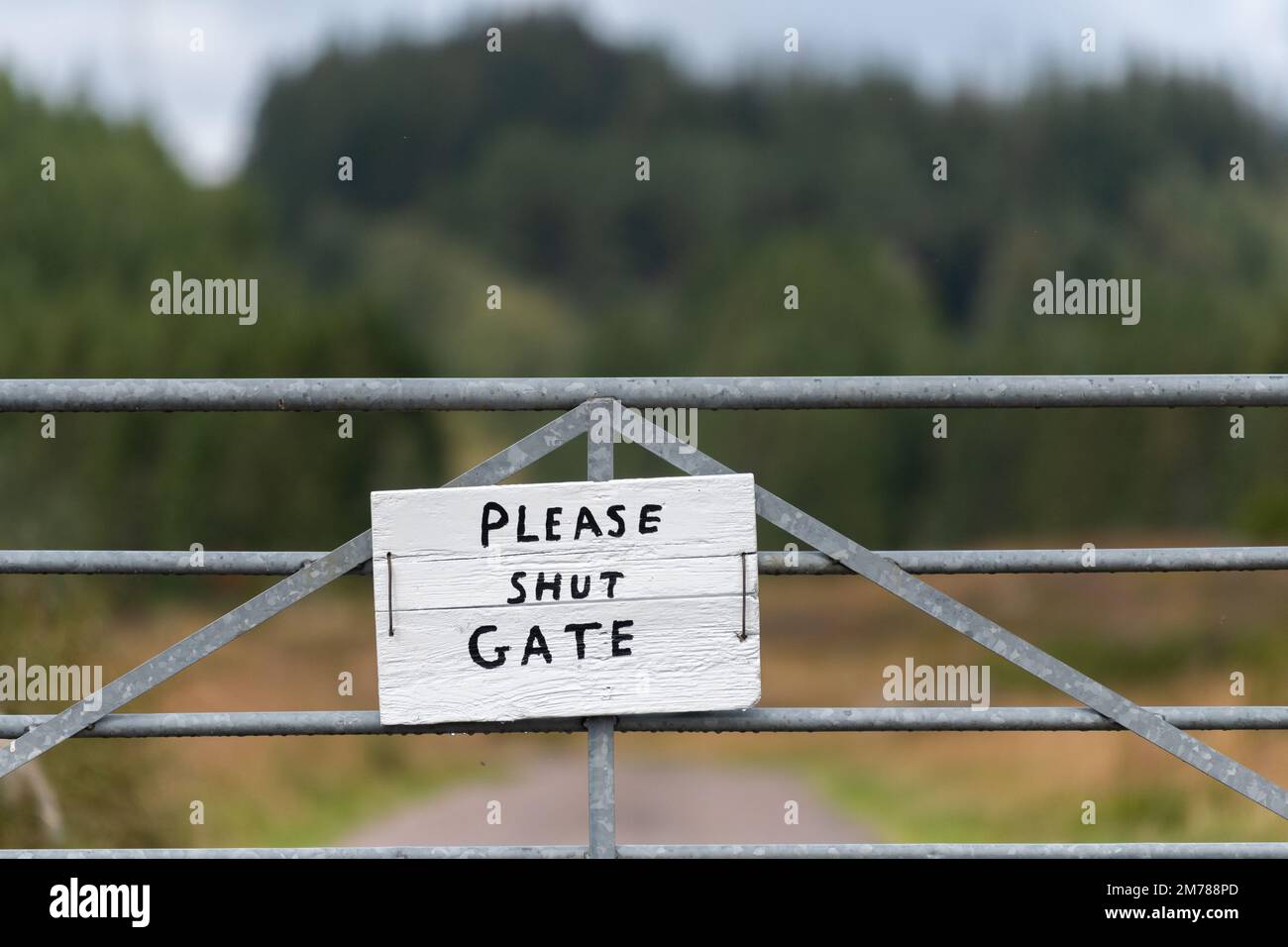 Narrow country lane with a gate on, sign on the gate saying "Shut the ...