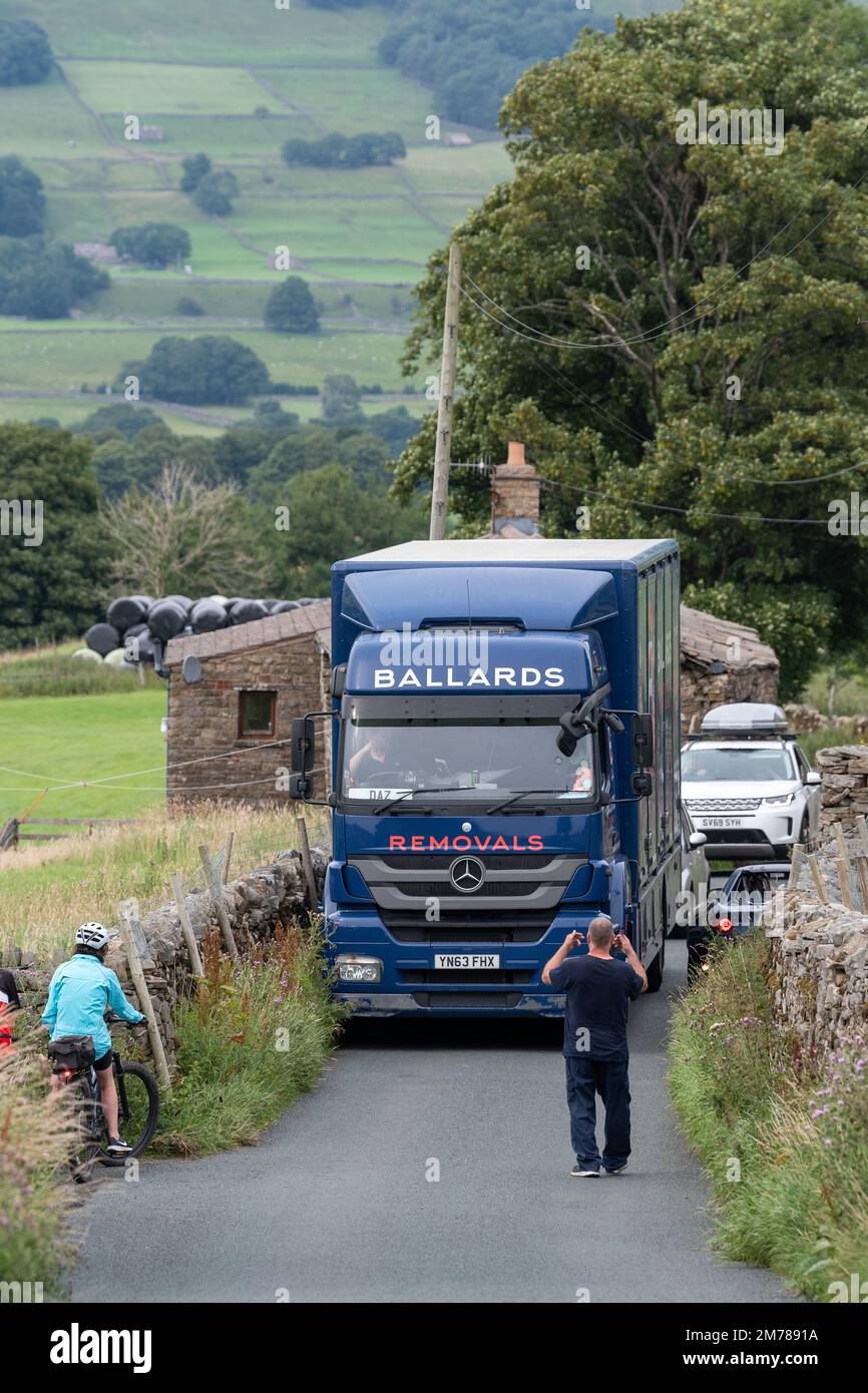 Removal lorry maneuvering up a very narrow country road, trying to ...