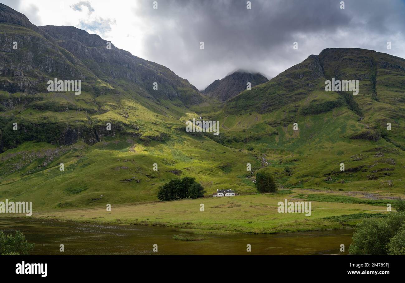 Small white cottage at the foot of the Three Sisters in Glencoe ...
