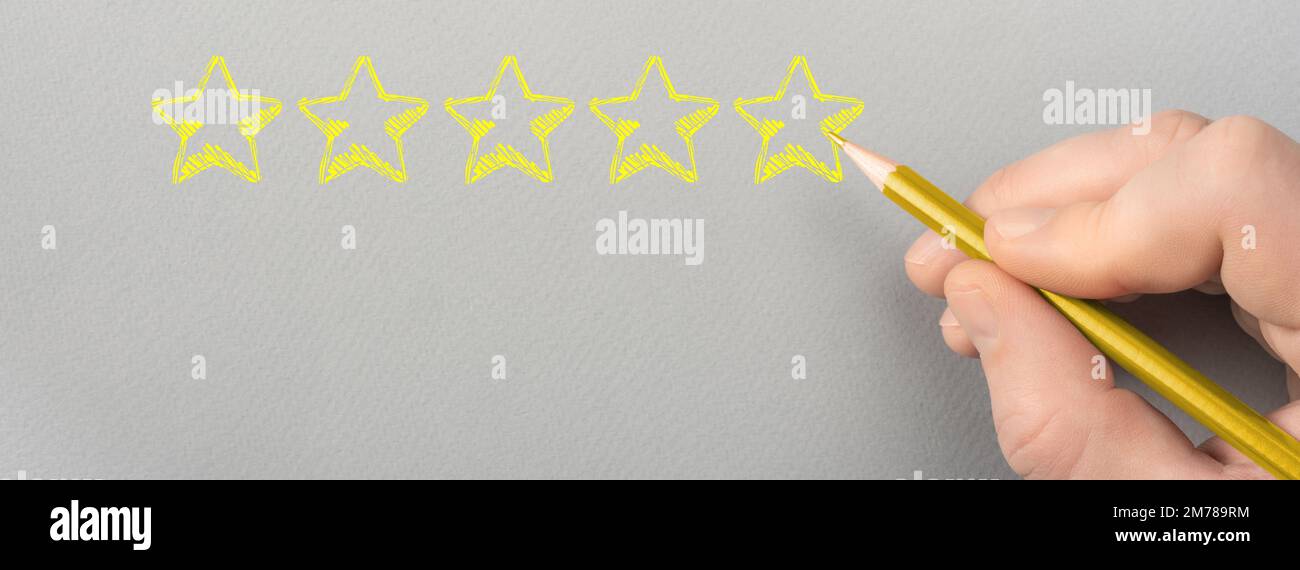 hand drawing 5 stars five stars rating on grey paper. Customer hand ...