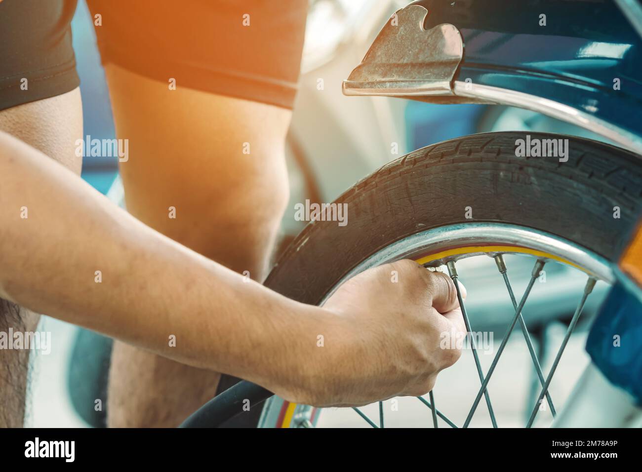 Hands of man check inflator pressure and inflates a tire on motorcycle ...