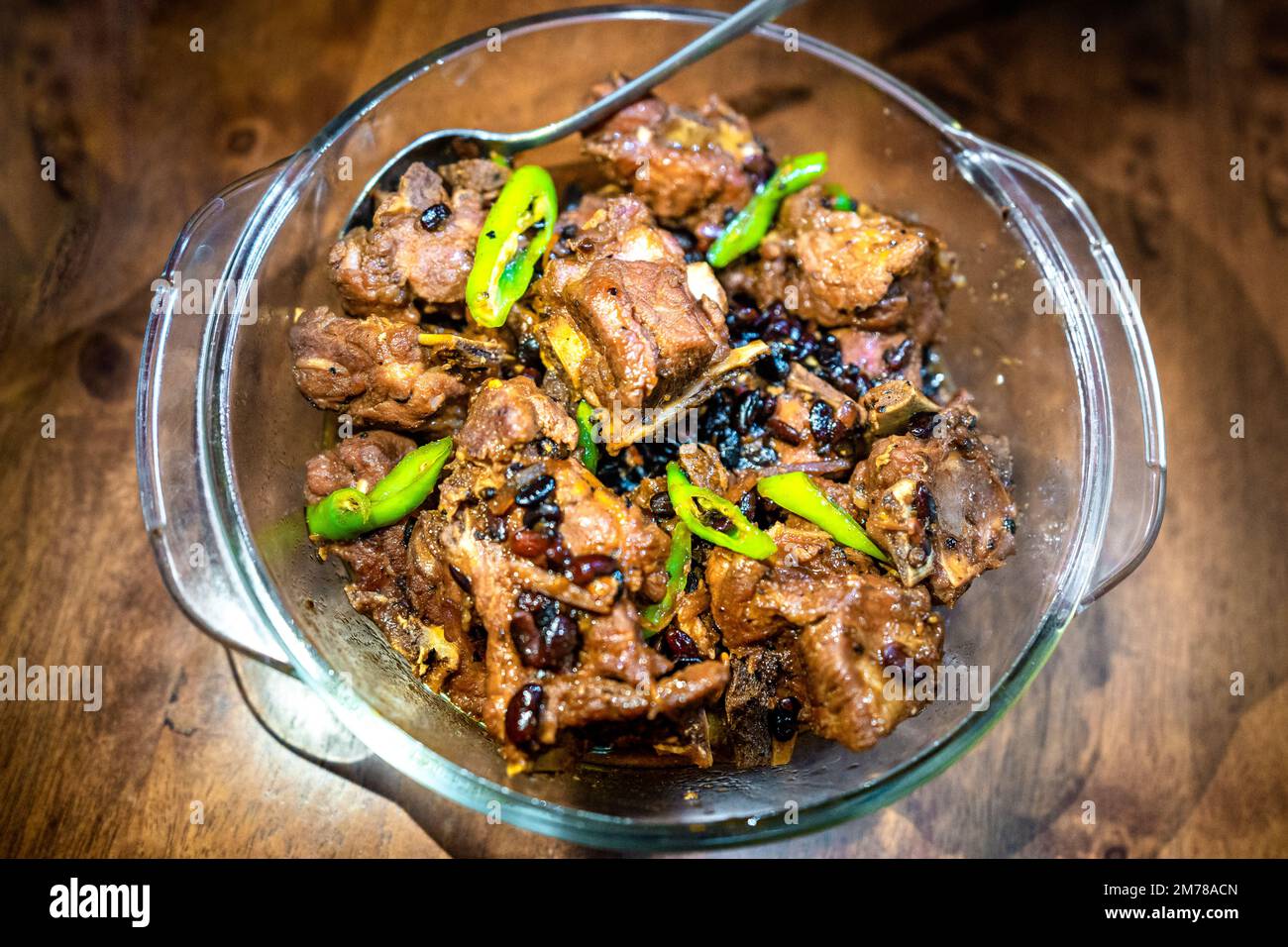 Sweet and sour pork ribs with tausi served in a bowl Stock Photo - Alamy