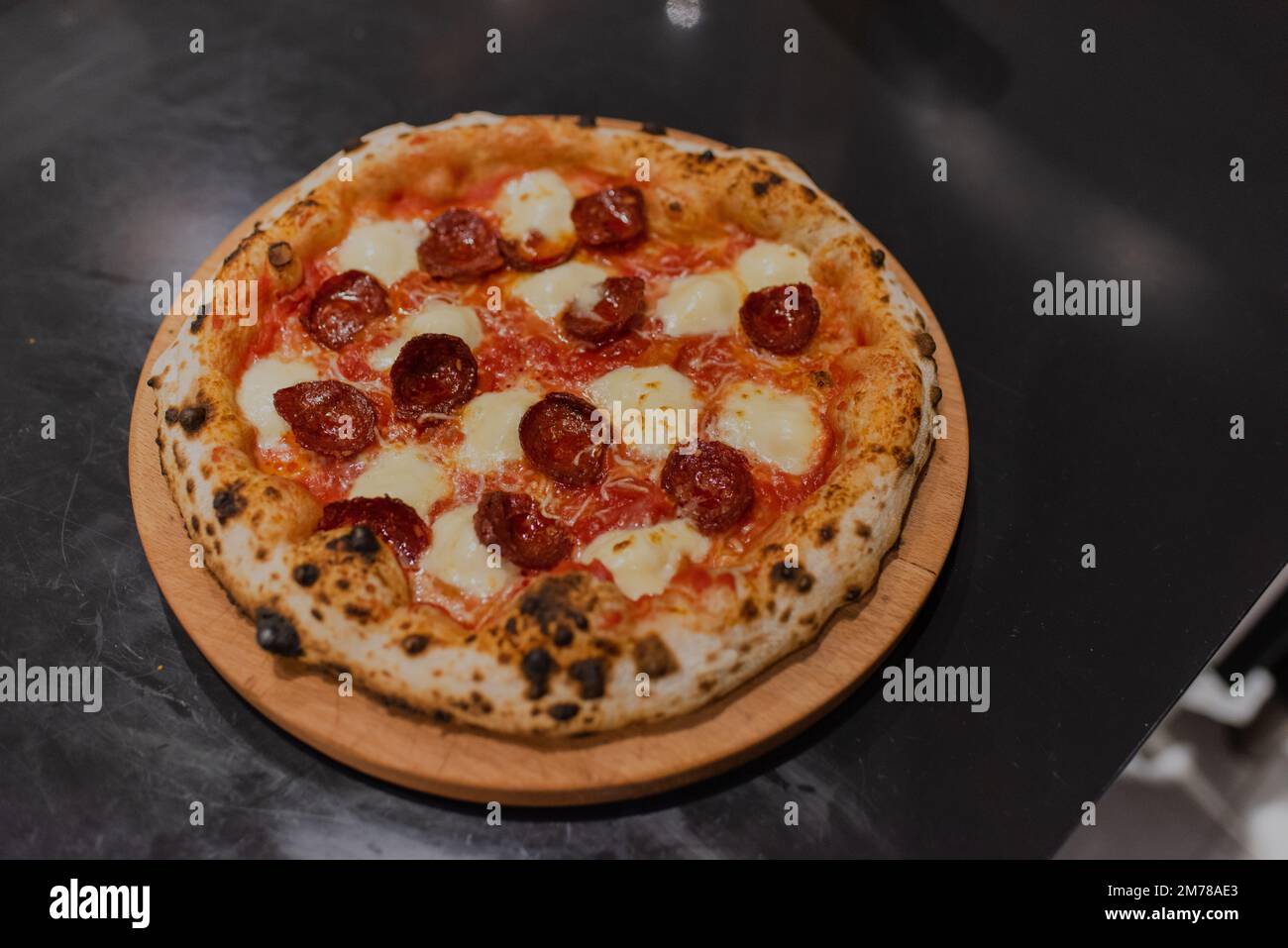 A top closeup of a newly baked pizza with sausage and cheese on the ...