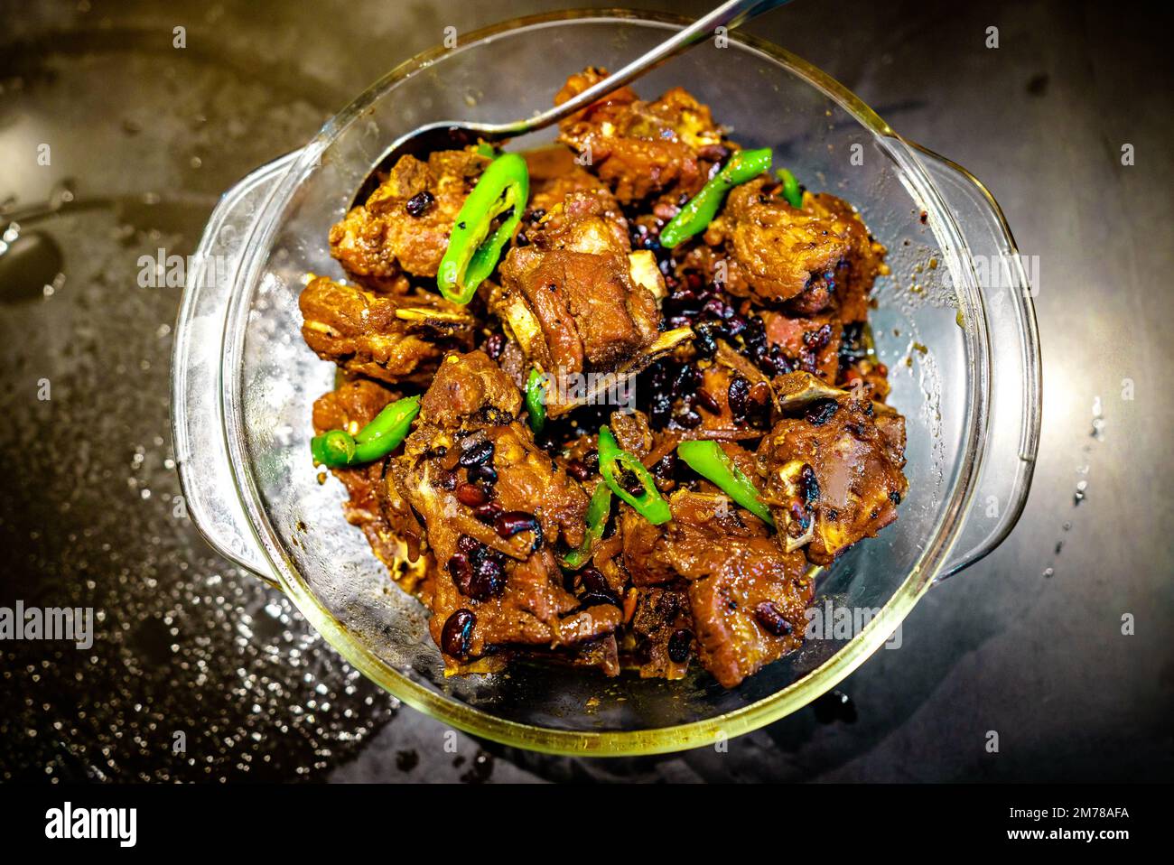 Sweet and sour pork ribs with tausi served in a bowl Stock Photo - Alamy