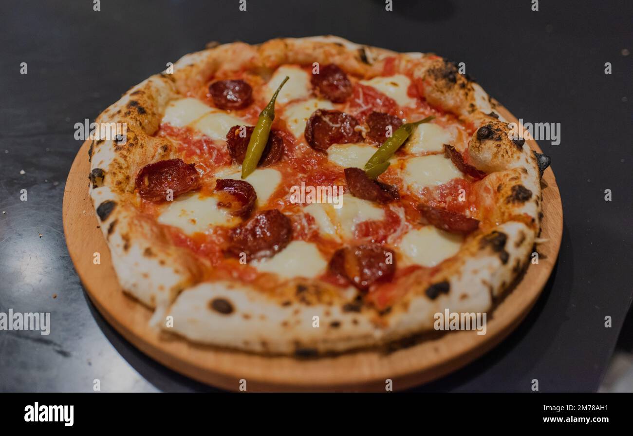 A top closeup of a newly baked pizza with sausage and cheese on the ...