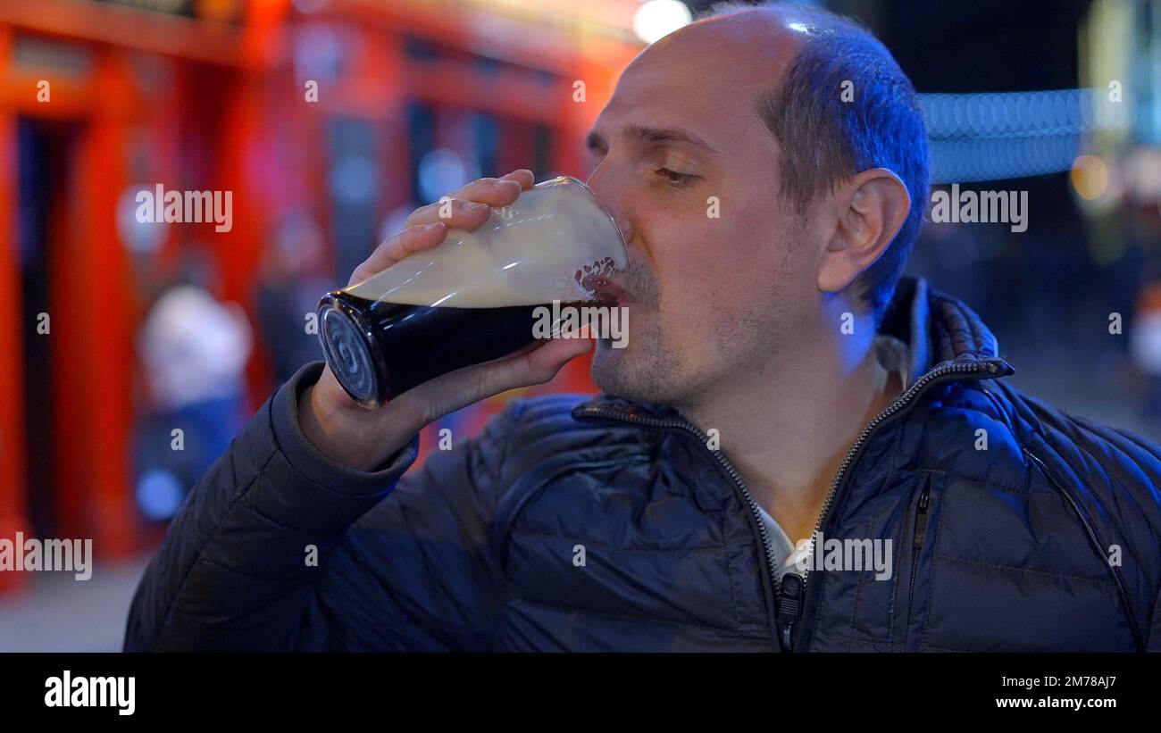 Guys drinking a beer in the Temple Bar district of Dublin by night - travel photography Stock ...