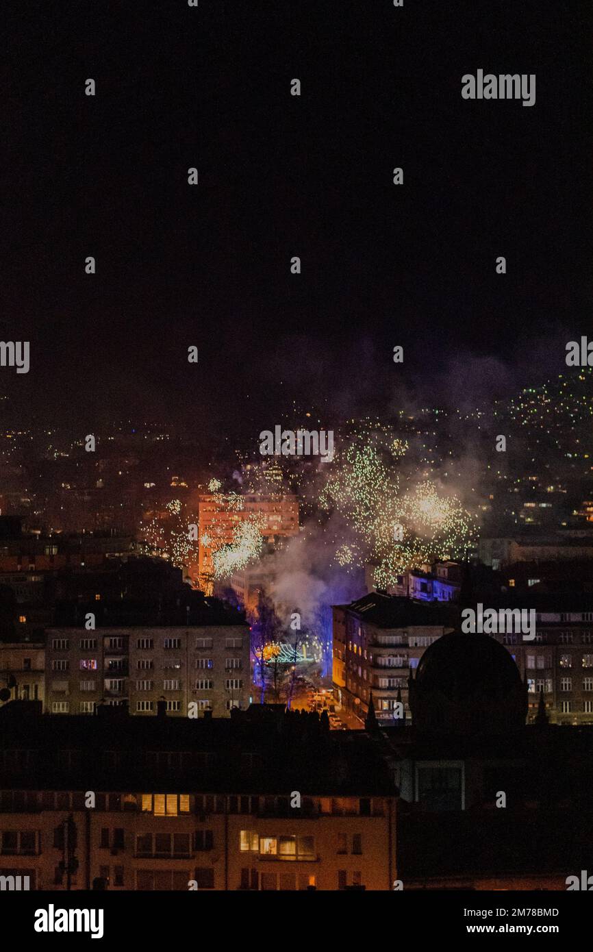 A high-angle of amazing colorful New Year fireworks against dark ...