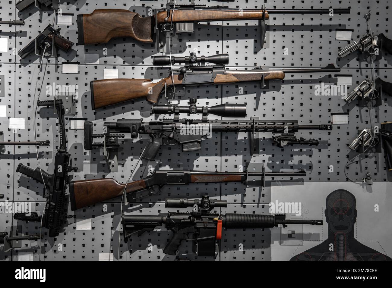 Collection of rifles and carbines. Various firearms hang on special ...