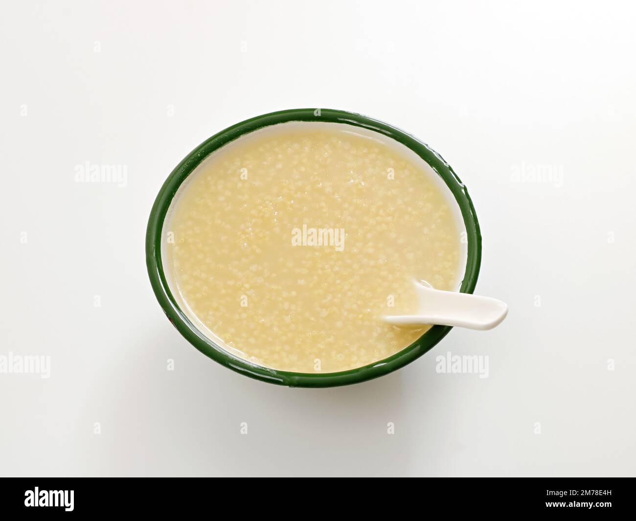 A close-up shot of millet porridge in a bowl on white background Stock ...