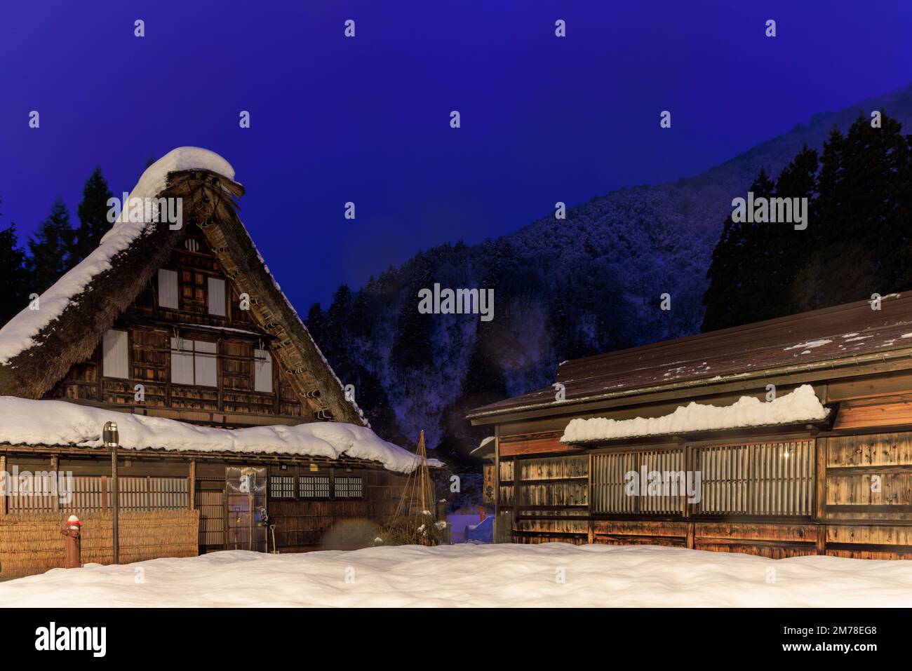 Traditional Japanese farmhouse and shed in snow covered mountains at ...