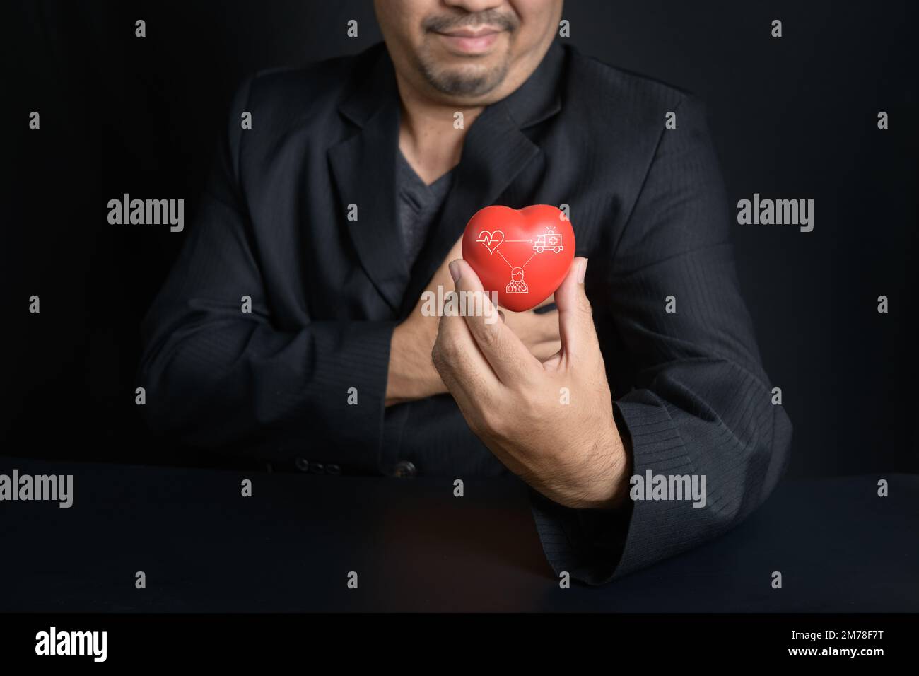 man holding red heart and feel chest pain on black background, medical ...