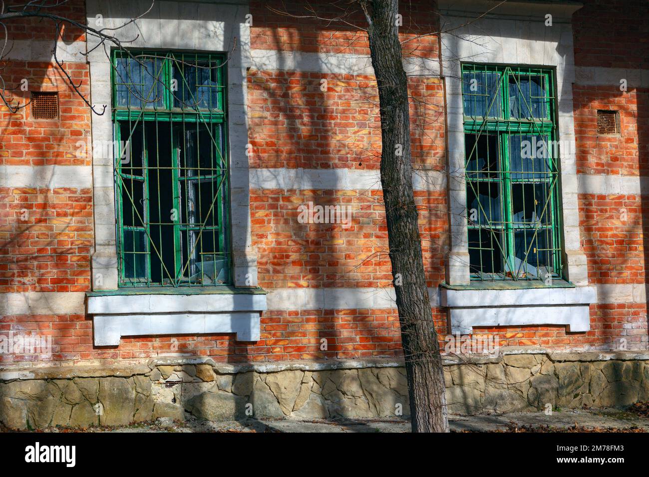 Brick wall and broken windows . Old abandoned building Stock Photo - Alamy