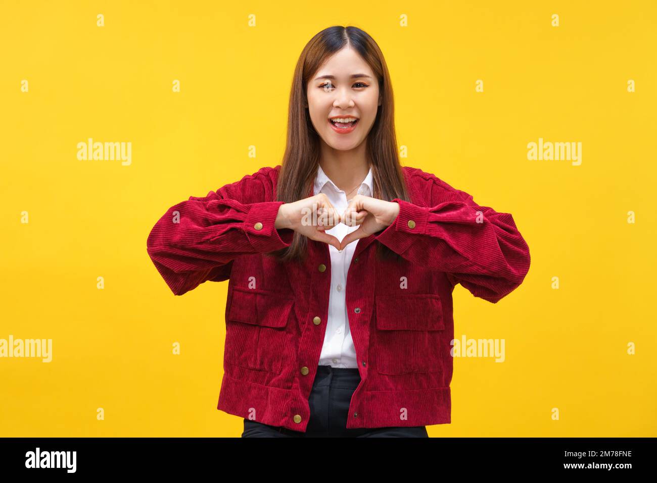 Women doing gesture heart shape with both hands and happiness smiling ...