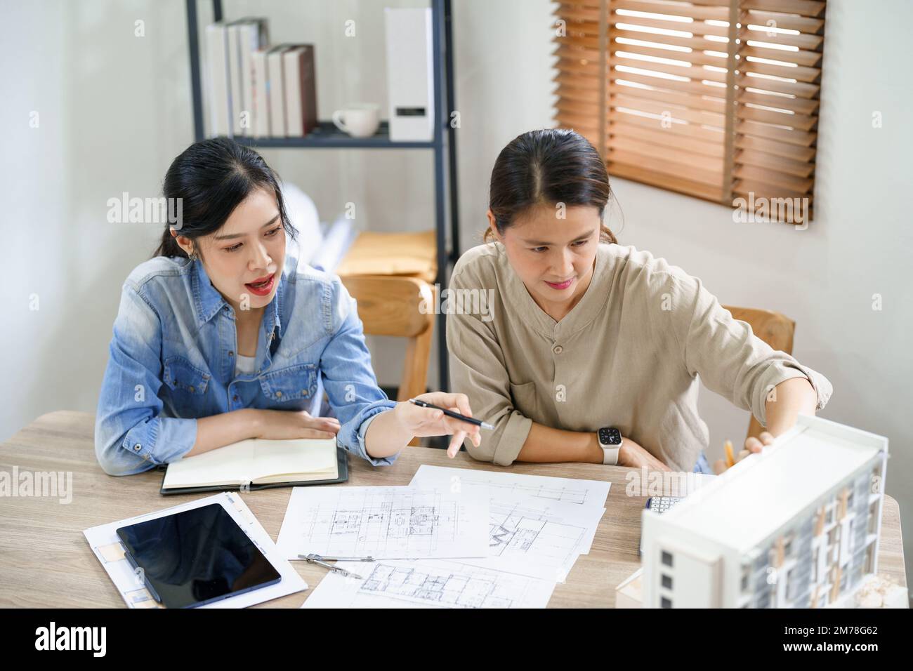 Engineering construction concept, Two female engineers pointing and ...