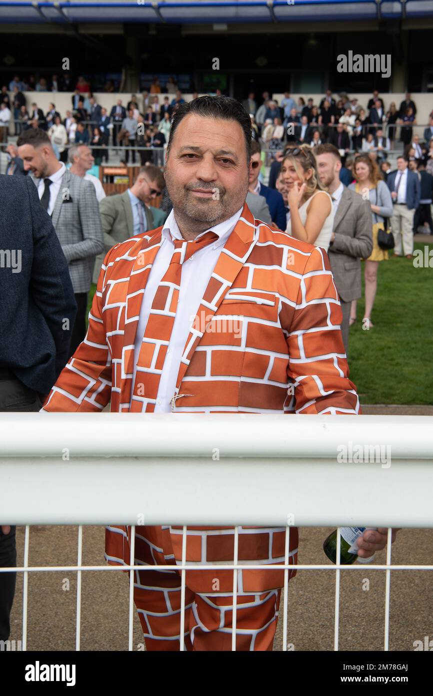 Ascot, Berkshire, UK. 7th May, 2022. A racegoer wears a whacky brick ...