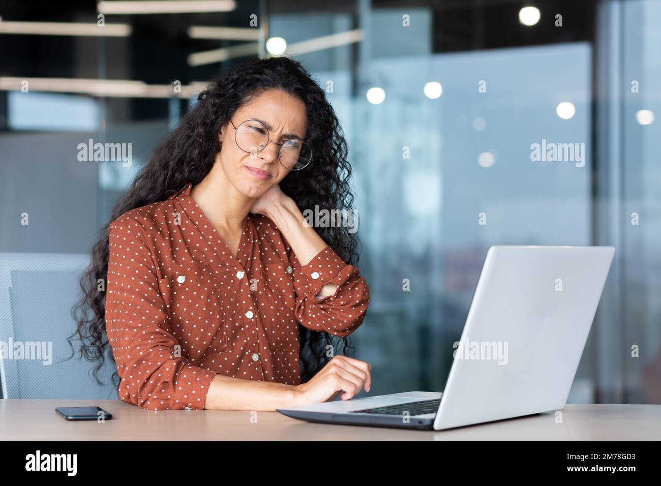 Tired young Latin American businesswoman, freelancer. He sits at the ...