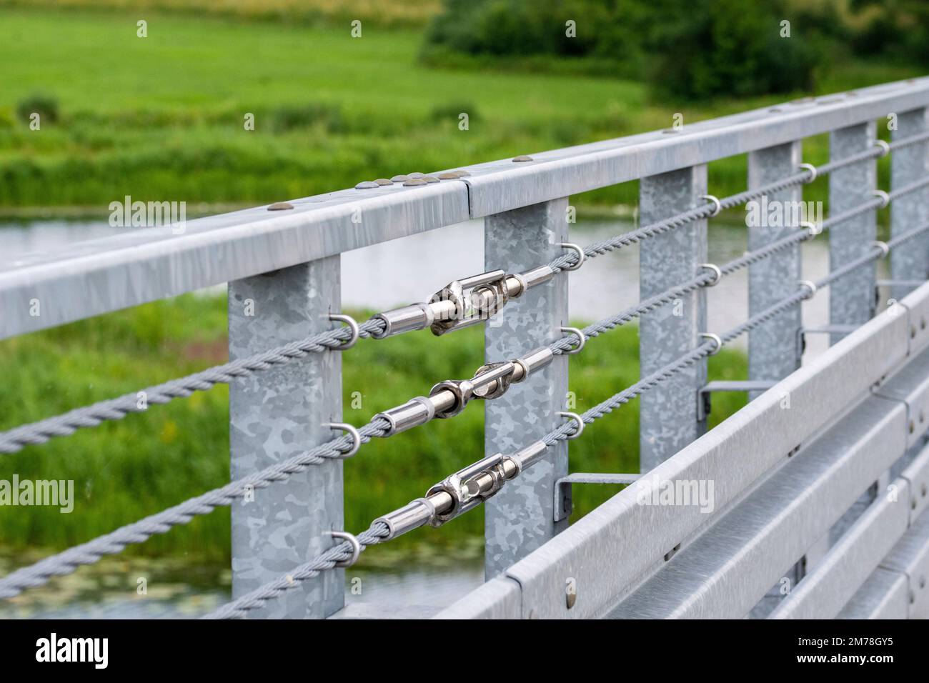 Turnbuckles connecting the safety ropes at the railing on the bridge ...