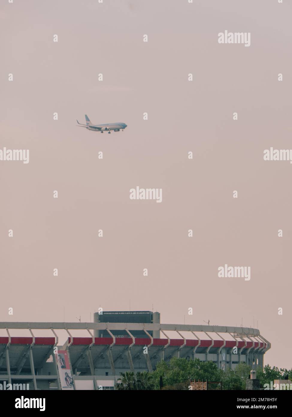 A vertical of a plane flying over the Monumental Stadium of the River ...