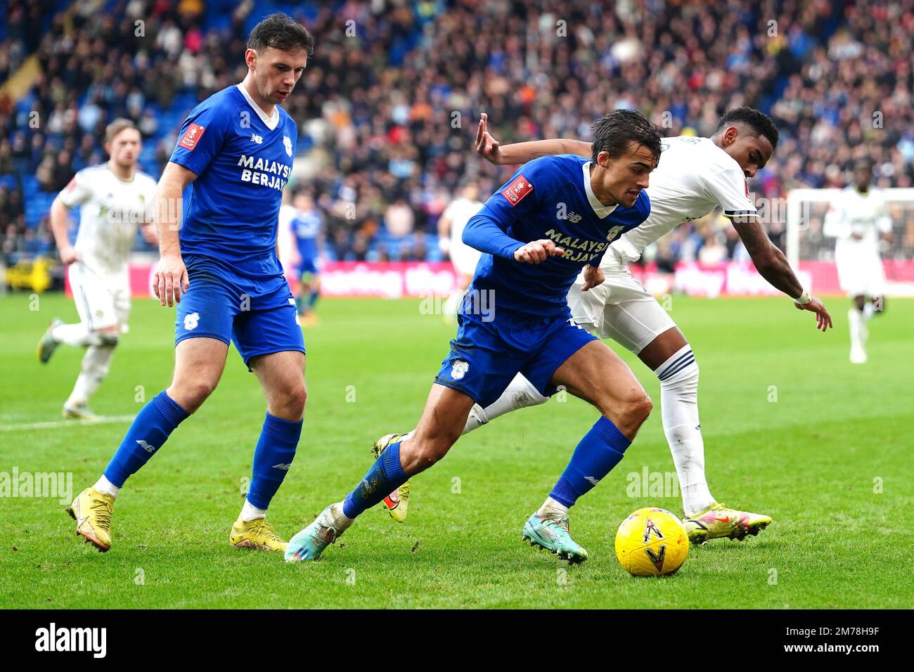 Cardiff City's Tom Sang and Leeds United's Junior Firpo (right) during ...