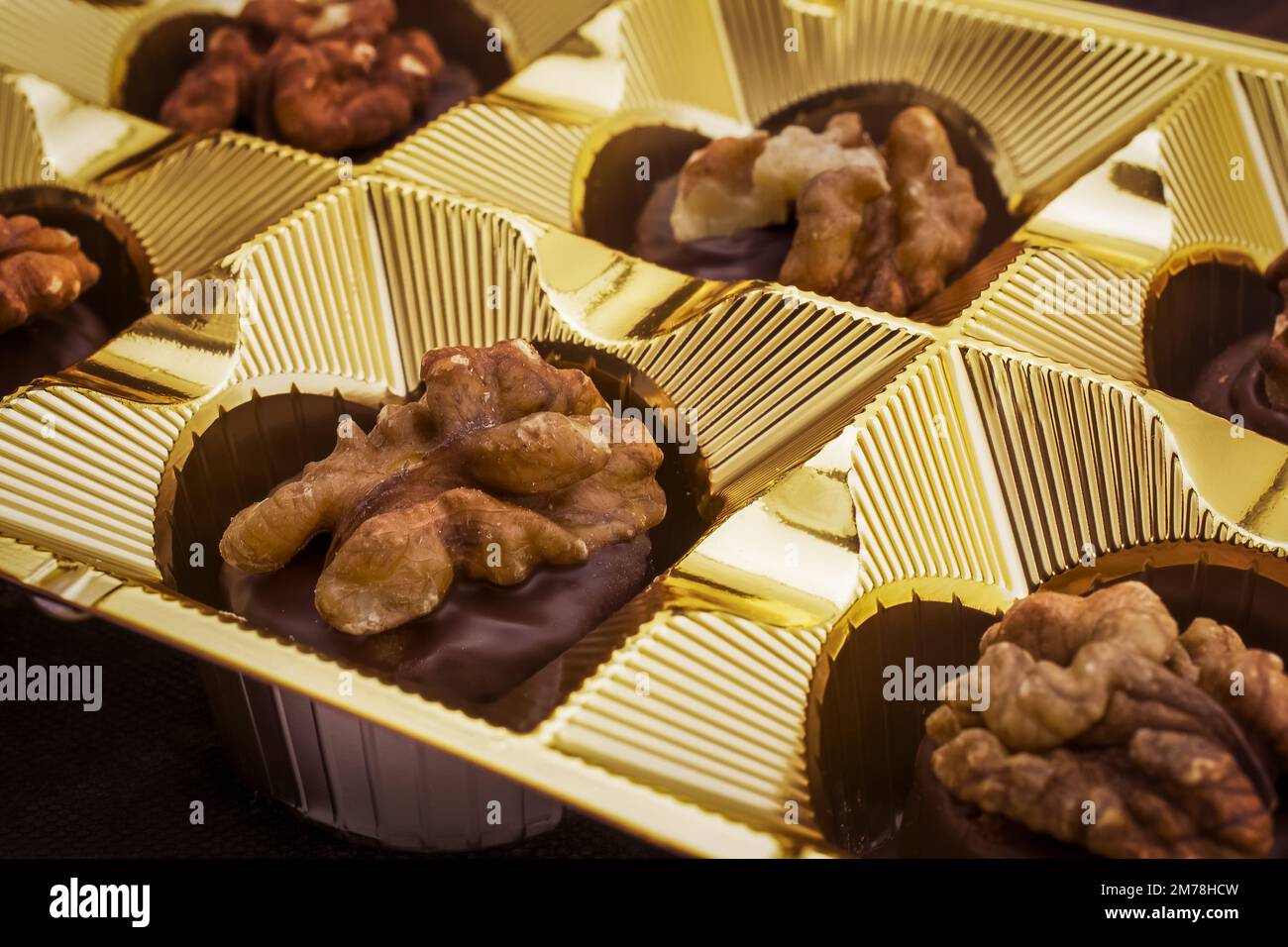 Close up of homemade with dark chocolate pralines filled with walnut ...