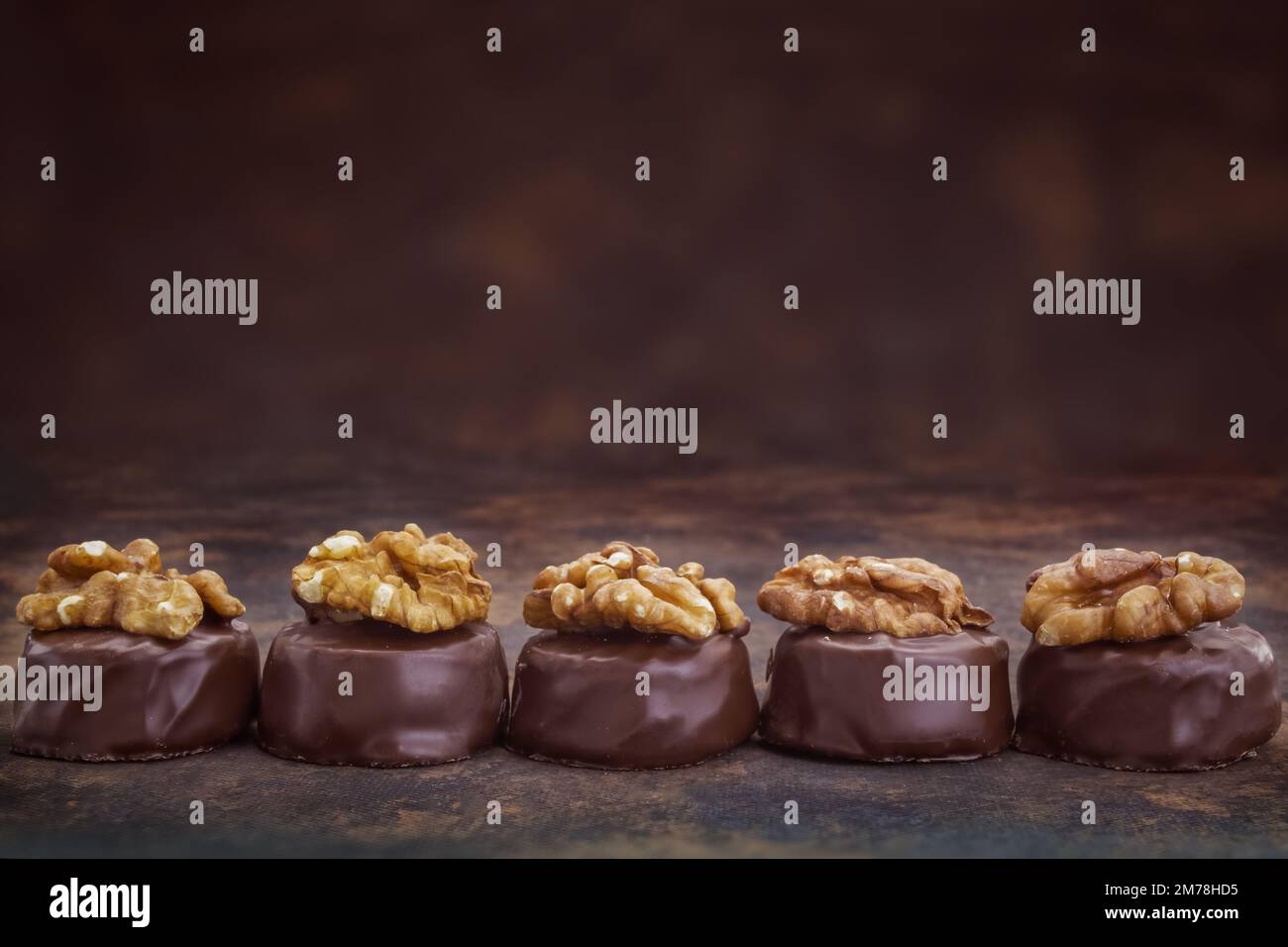 Close up of homemade with dark chocolate pralines filled with walnut ...