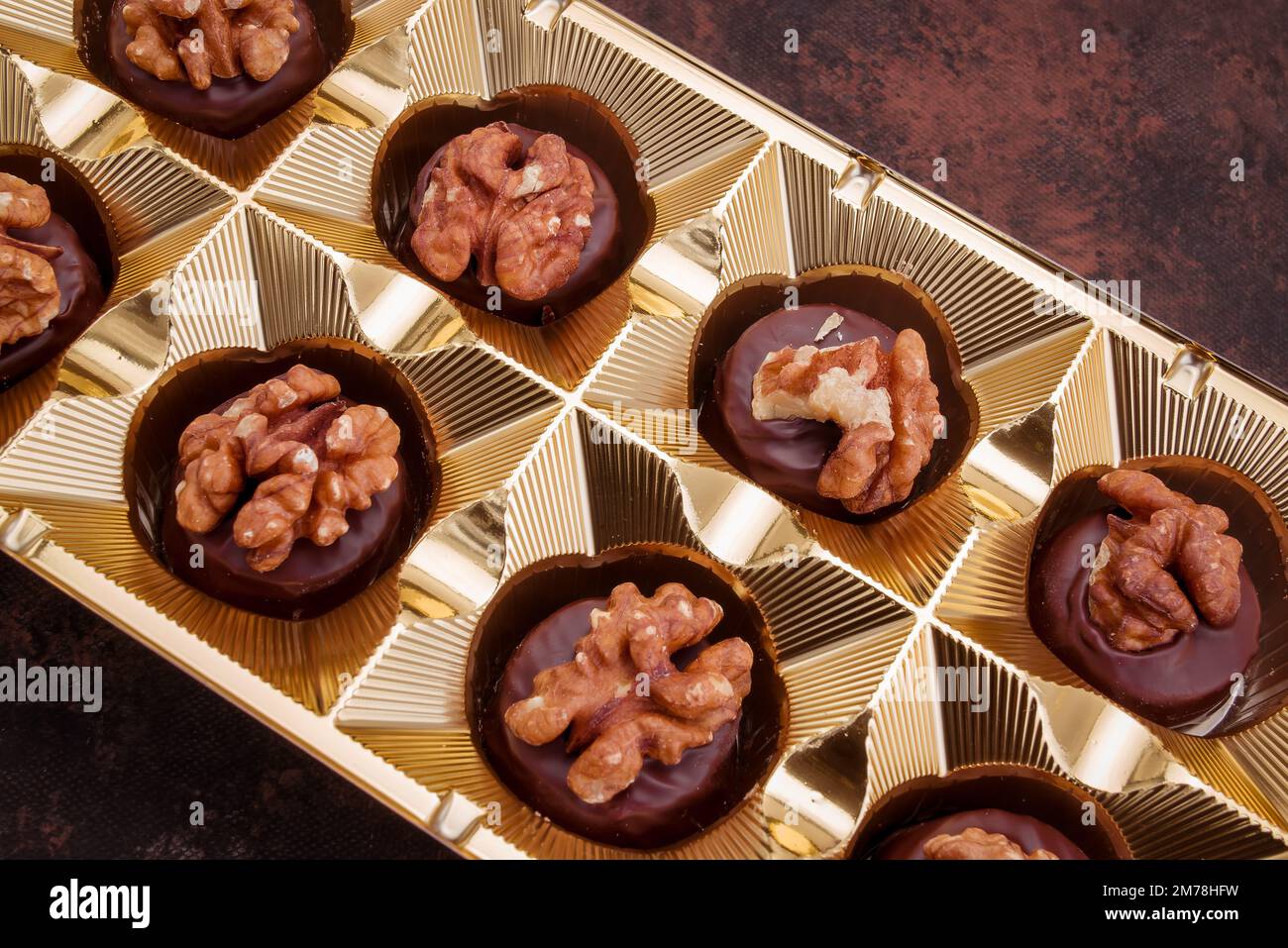 Close up of homemade with dark chocolate pralines filled with walnut ...