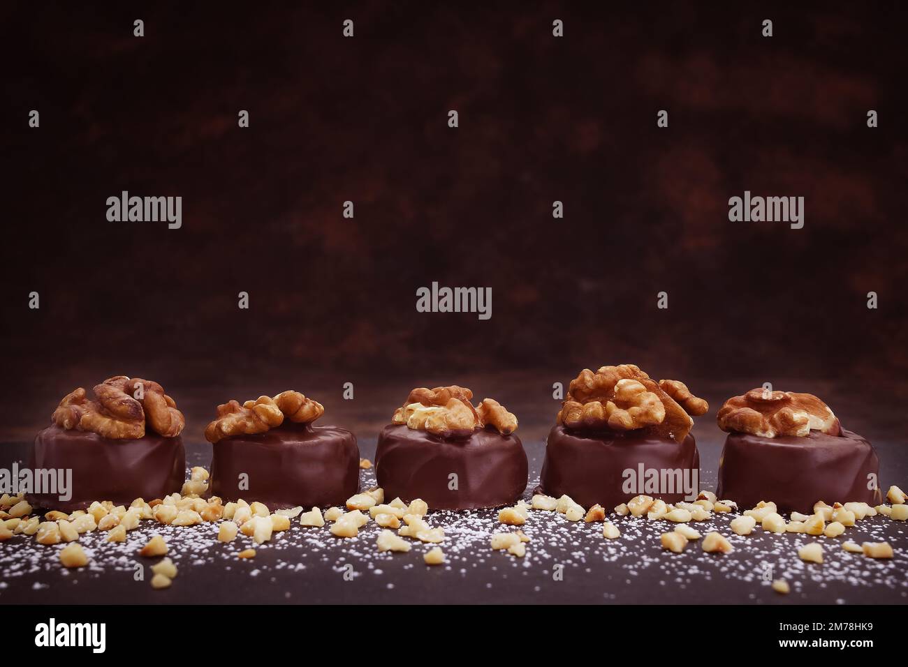 Close up of homemade with dark chocolate pralines filled with walnut ...