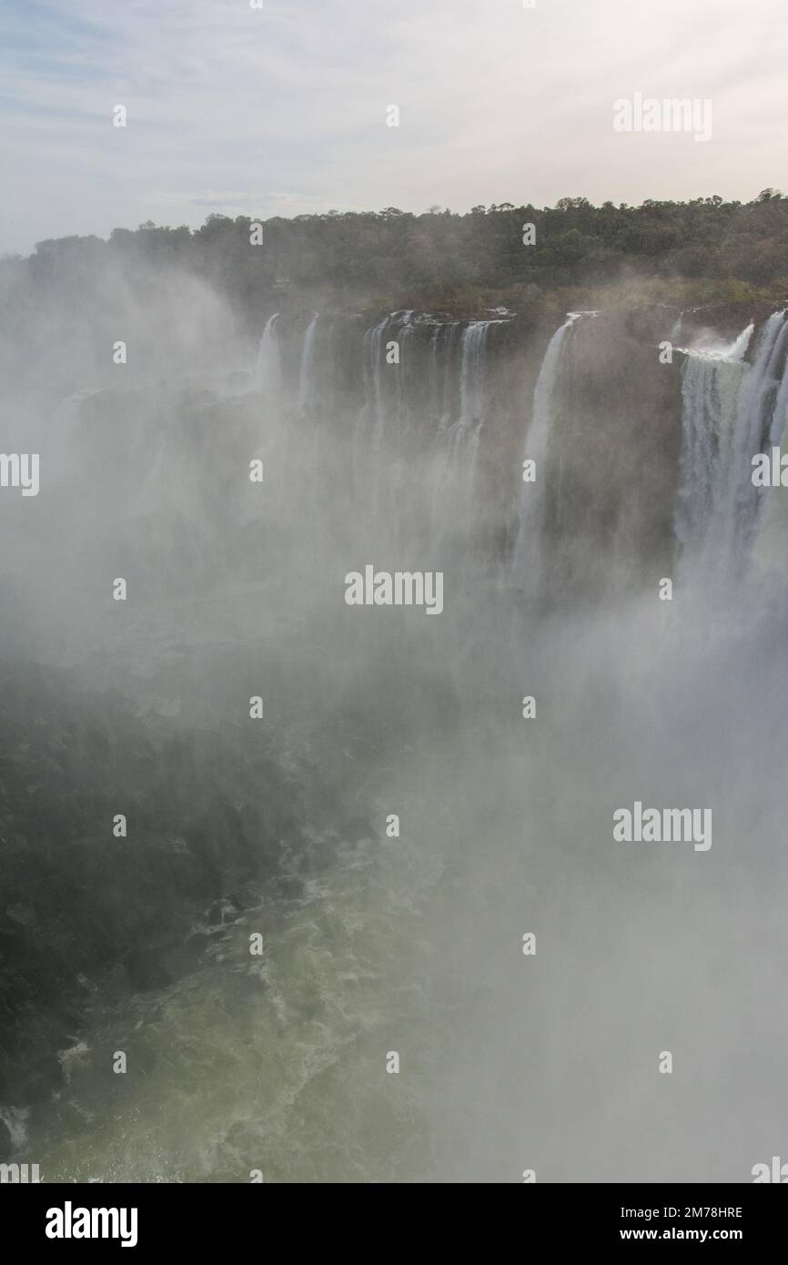 A landscape scene of Devil's Throat waterfalls with trees in Argentina ...