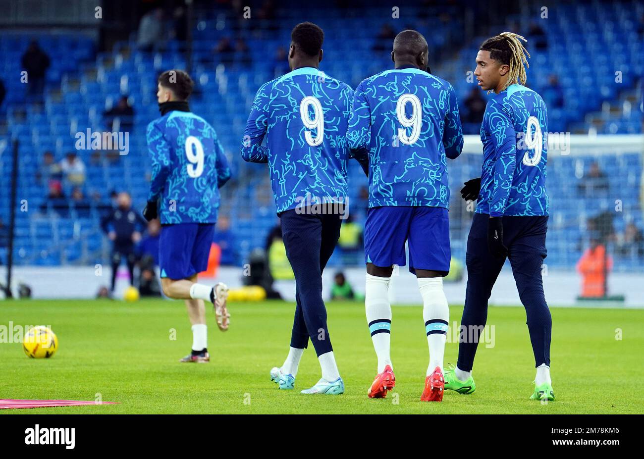 Chelsea players warm up on the pitch wearing number 9 on their tops in ...