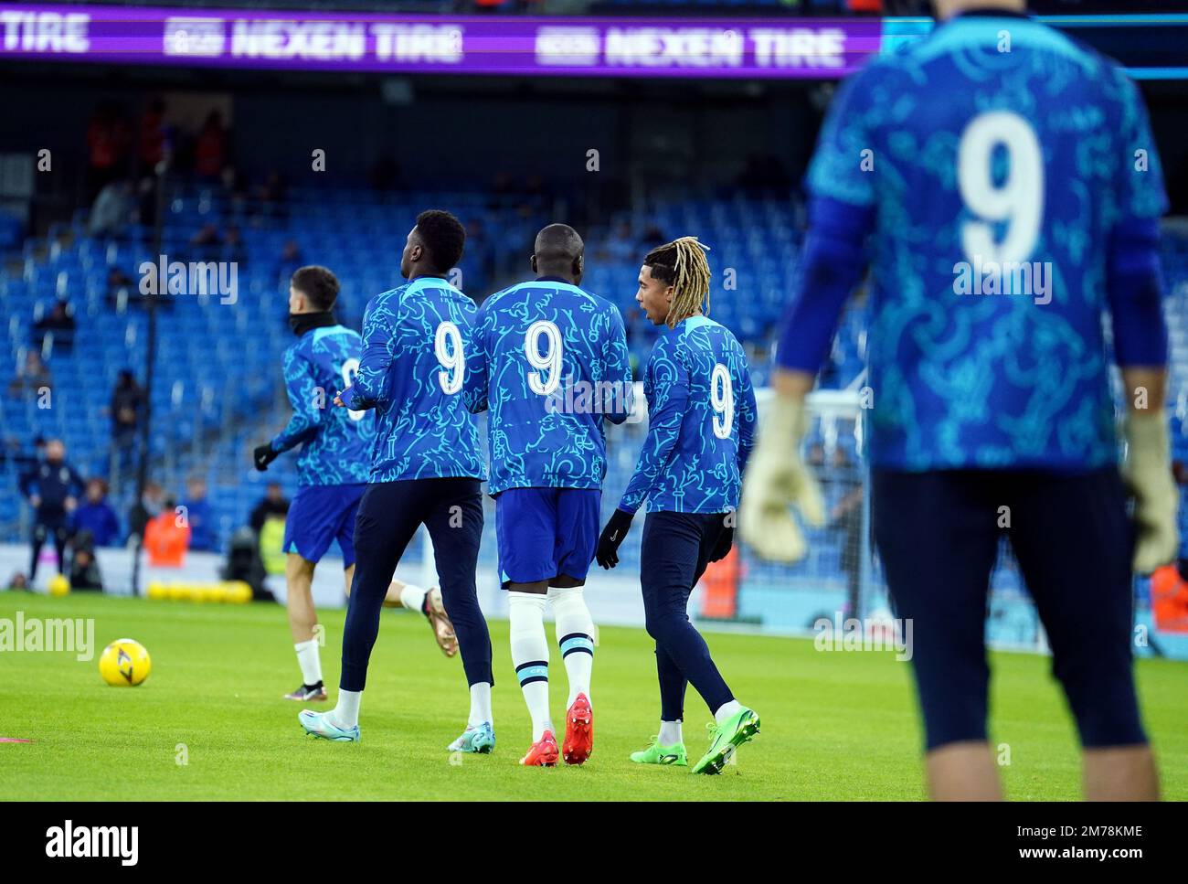 Chelsea players warm up on the pitch wearing number 9 on their tops in ...