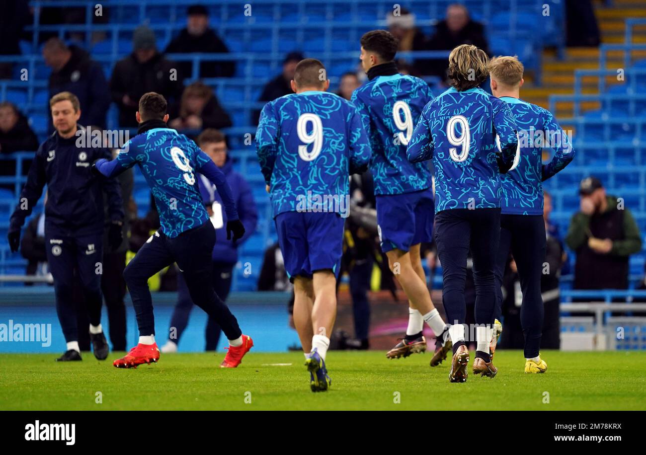 Chelsea players warm up on the pitch wearing number 9 on their tops in ...