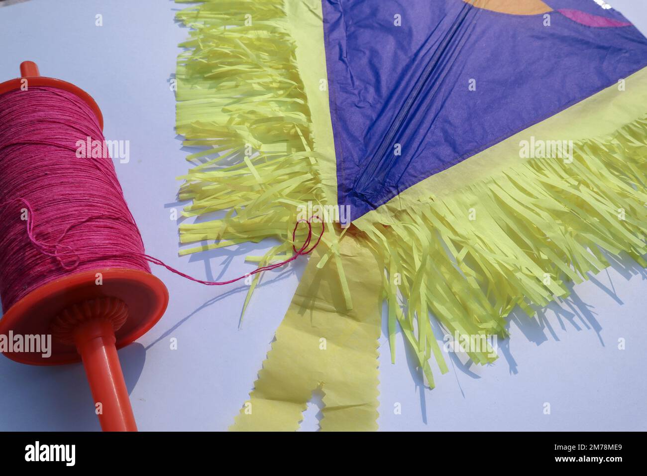 Colour kite with spool on white background Stock Photo - Alamy