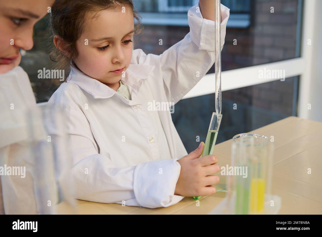 Smart Caucasian 5-6 years old little child , schoolgirl dripping ...