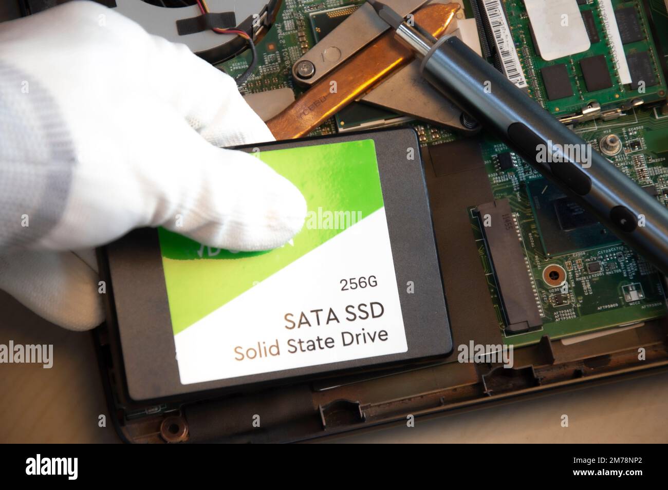 Technician installing ssd drive in old computer, upgrading computer ...