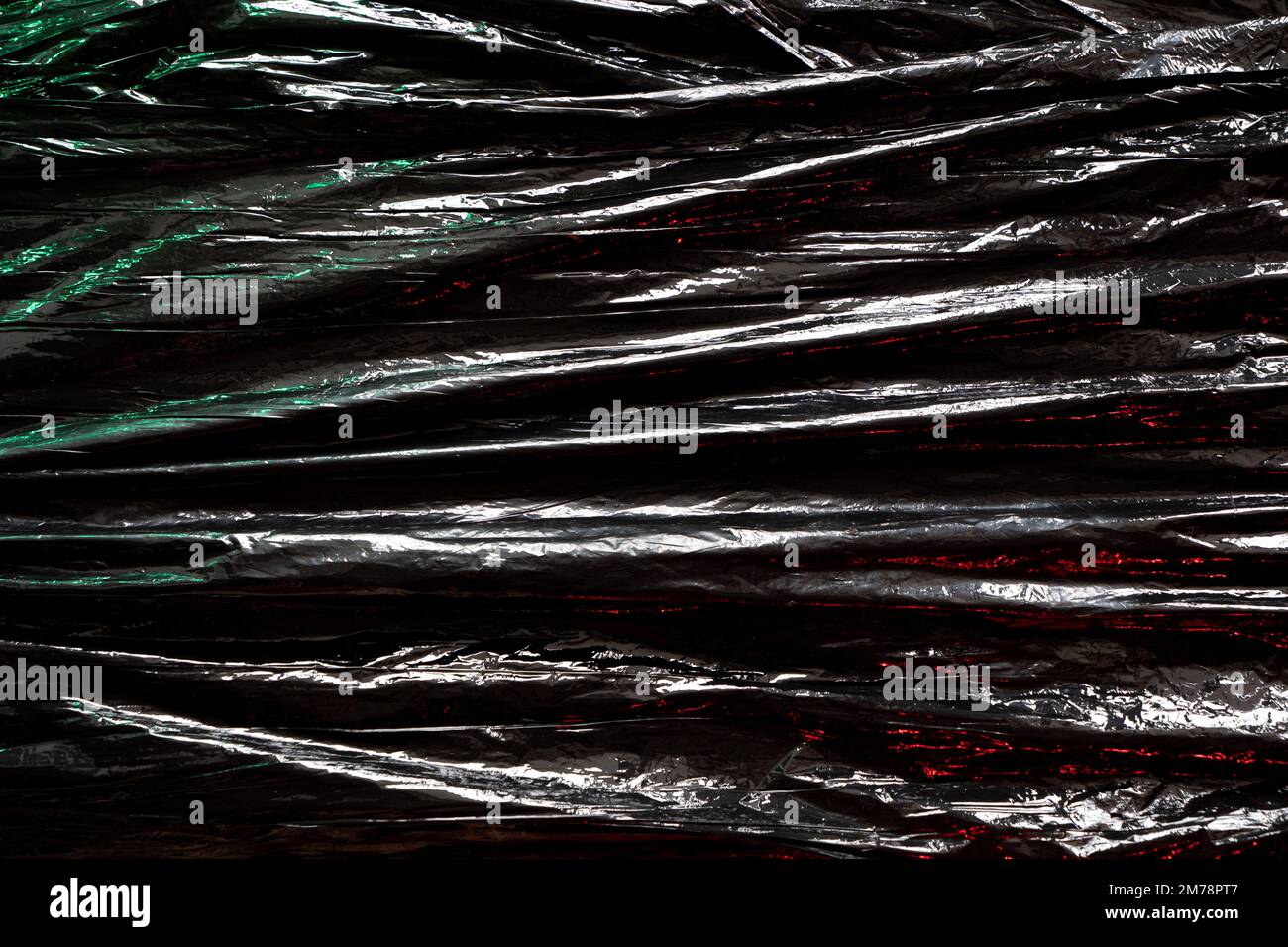 Black color plastic wrap background. Dark crumpled wrinkled plastic ...