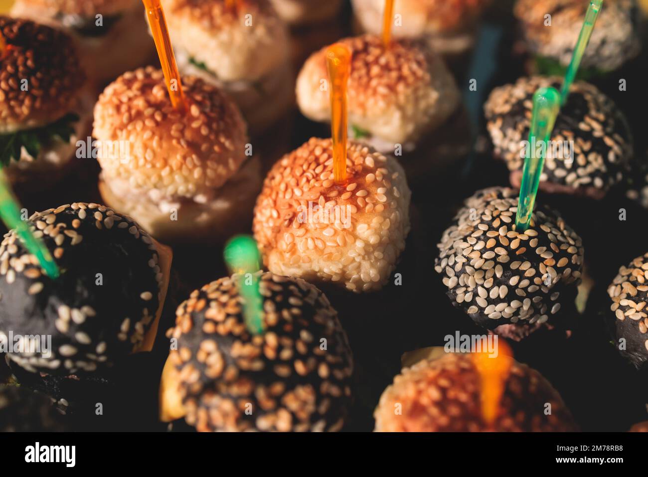 Burger mini burgers snacks on a wooden table with craft paper ...