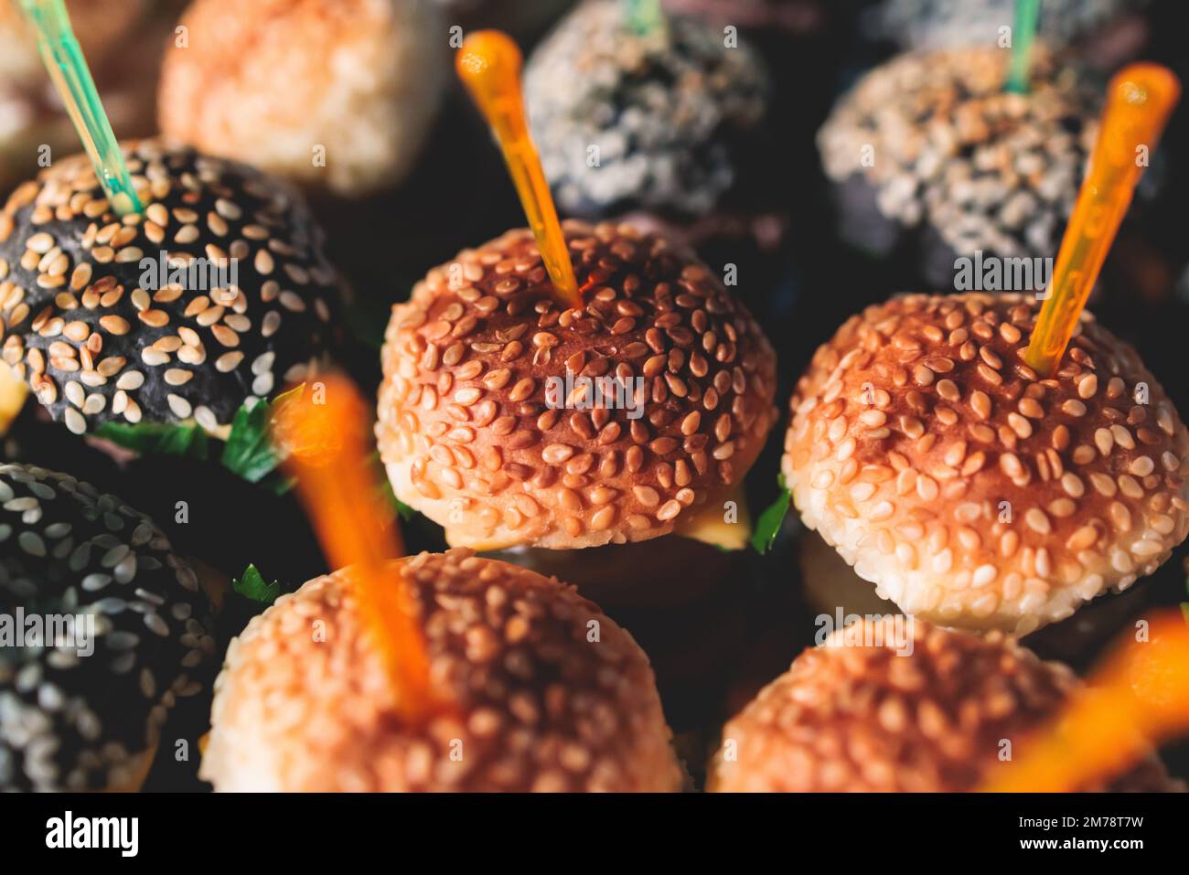 Burger mini burgers snacks on a wooden table with craft paper ...