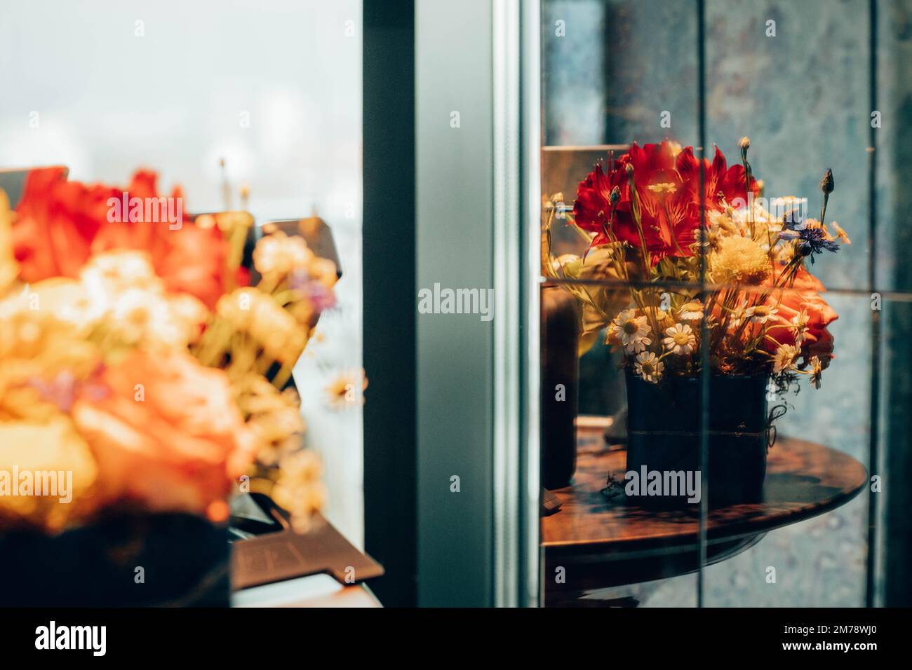 A reflection of a decorative vase with a bouquet in a window Stock ...