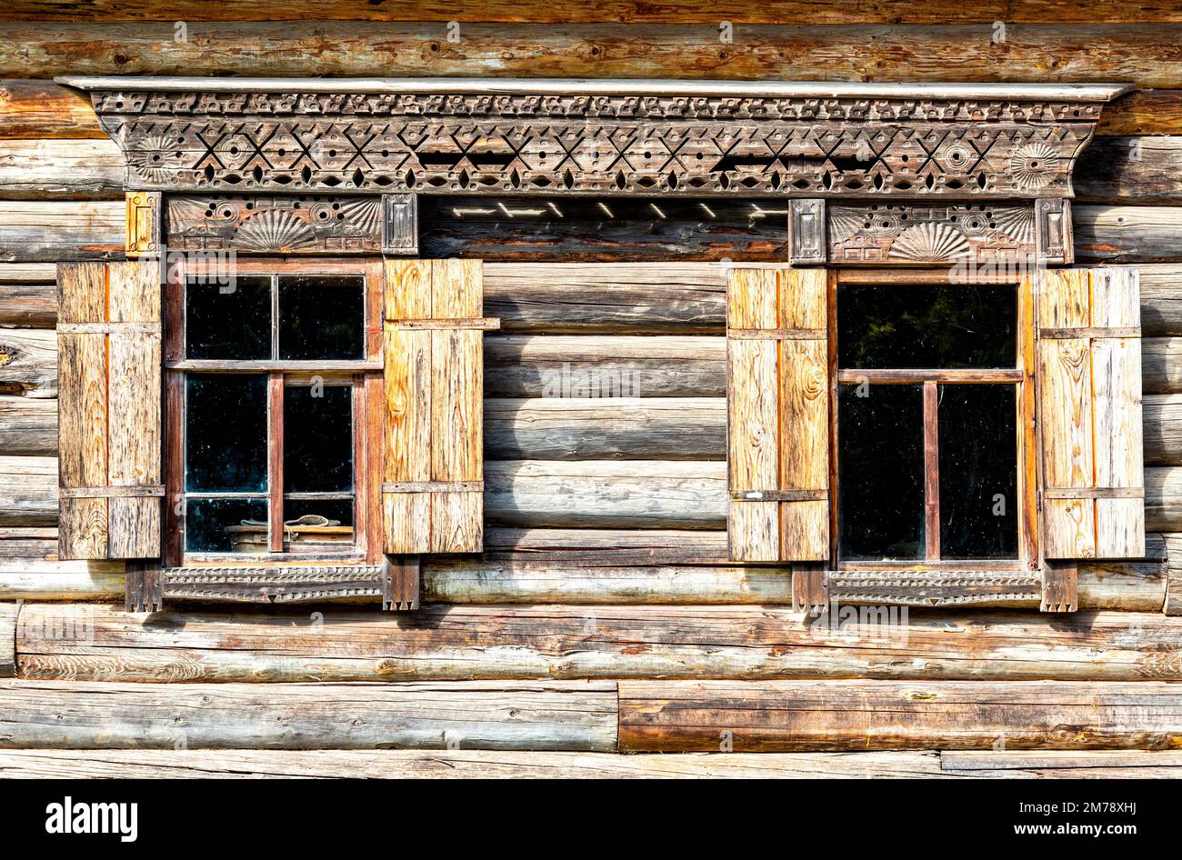 Windows of old traditional russian log house with carved wooden trim ...