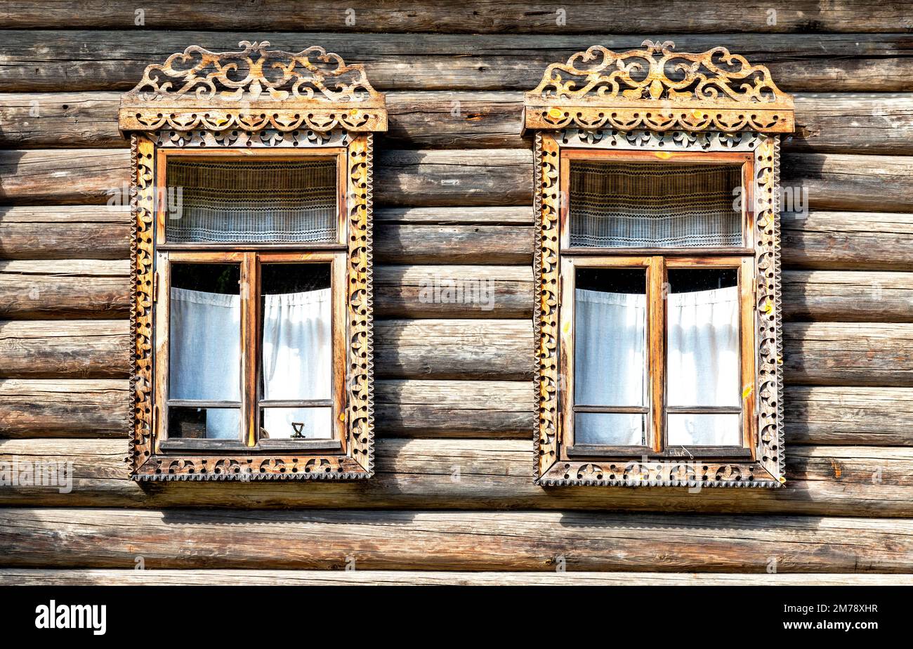 Windows of old traditional russian log house with carved wooden trim ...