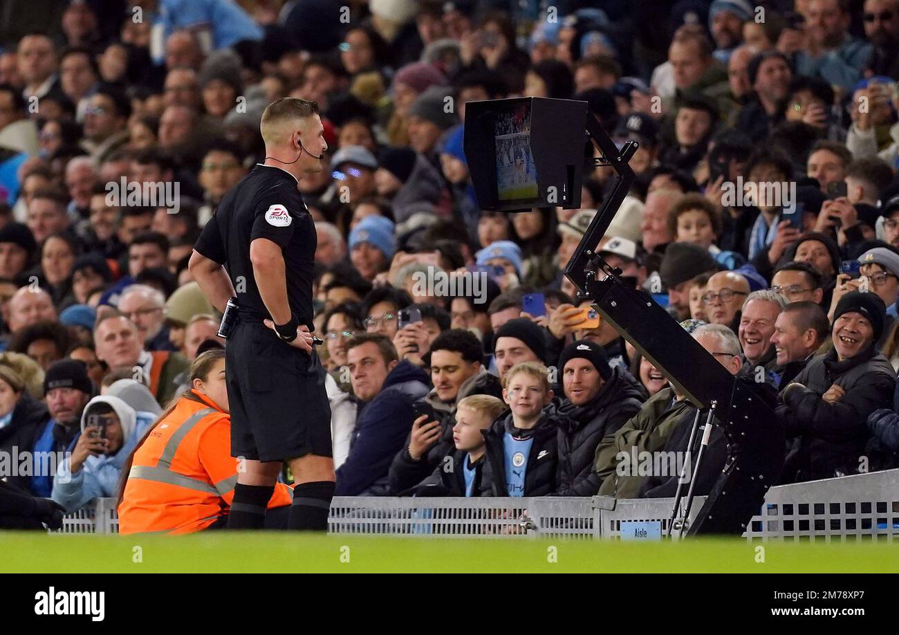 Referee Robert Jones checks the pitch side VAR monitor before awarding ...